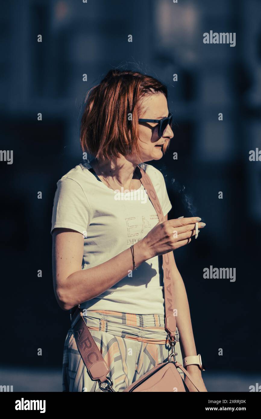 Timisoara, Romania - April 28, 2024: Woman smoking a cigarette while ...
