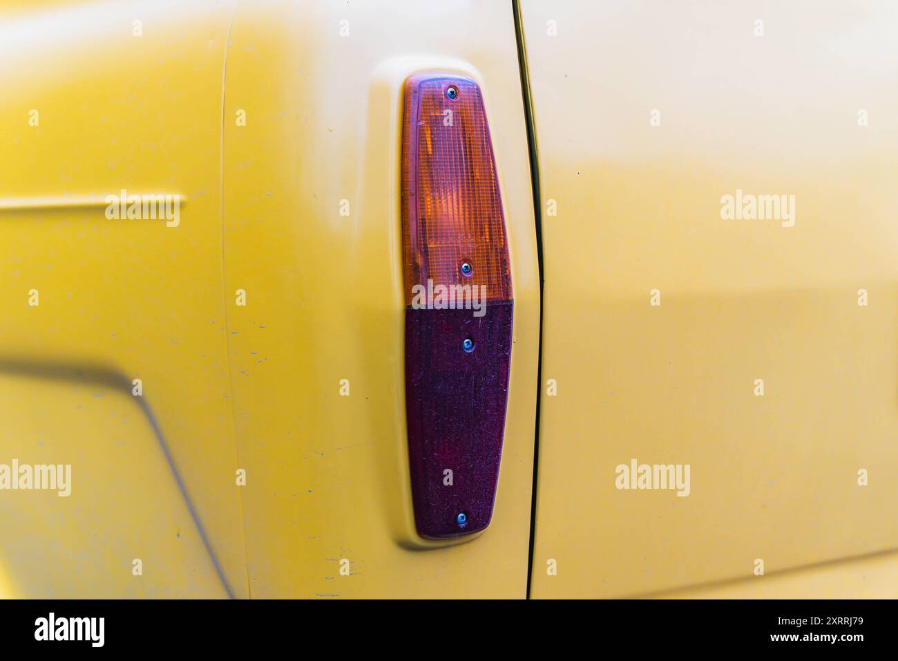 Close-up of a yellow cars rear turn signal and taillight Stock Photo ...