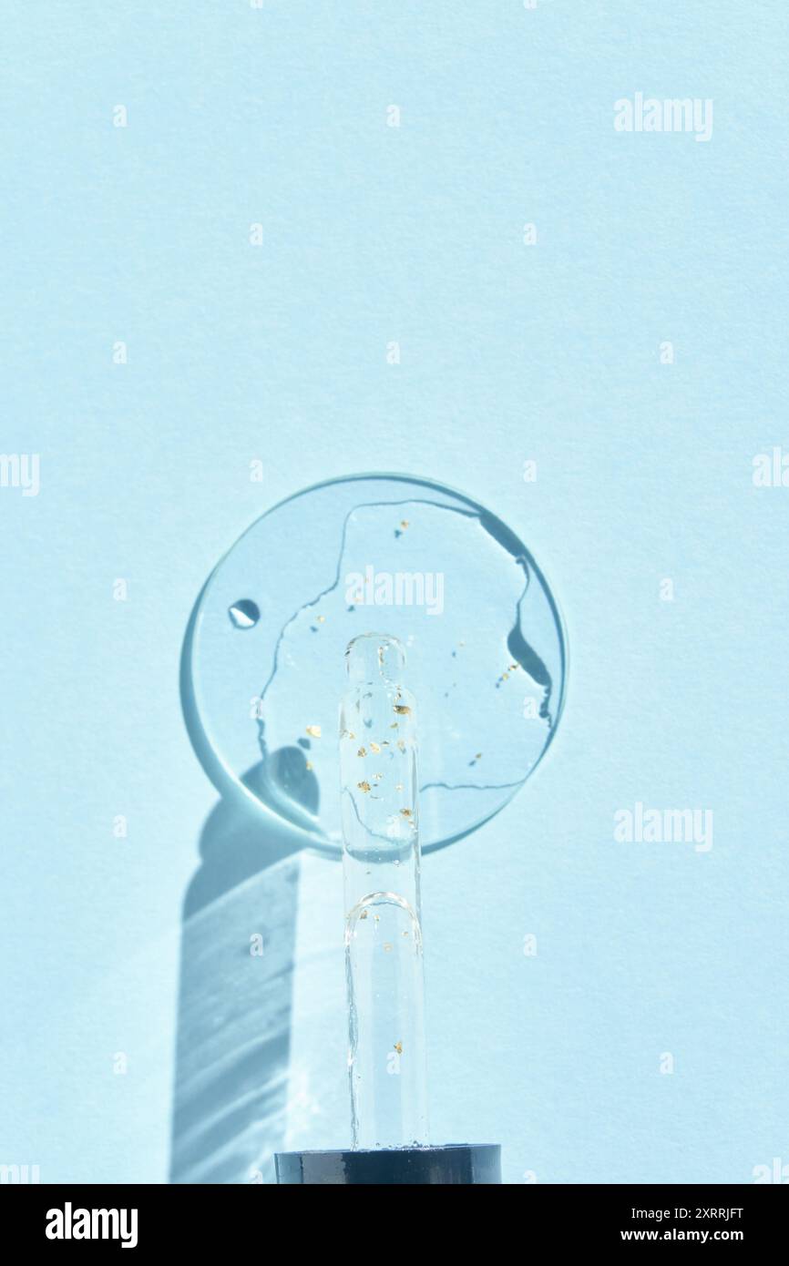 Serum gel texture swatch. Transparent drop with golden sparkles. Blue ...
