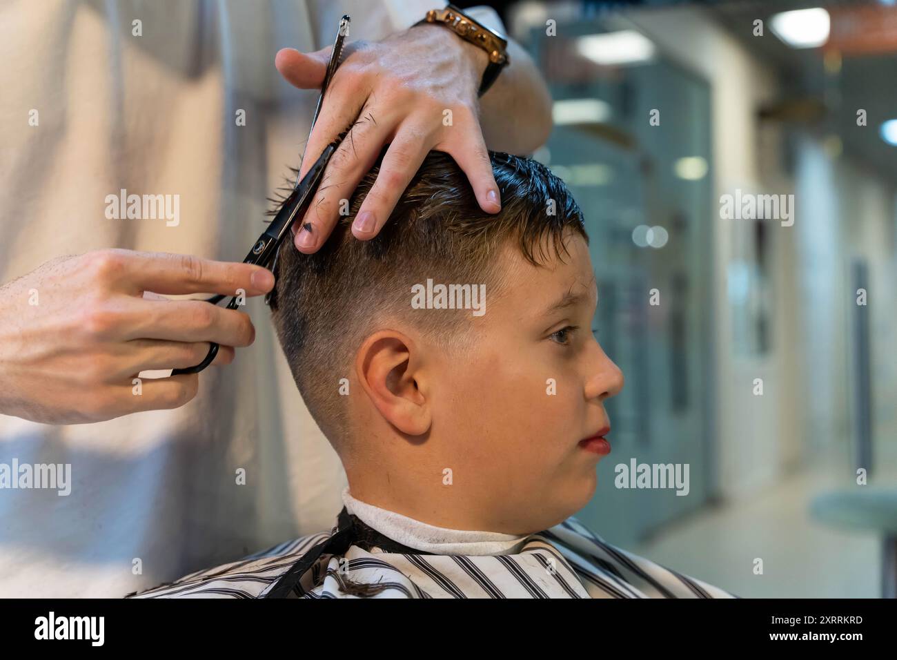 Barber cutting boys hair hi-res stock photography and images - Alamy