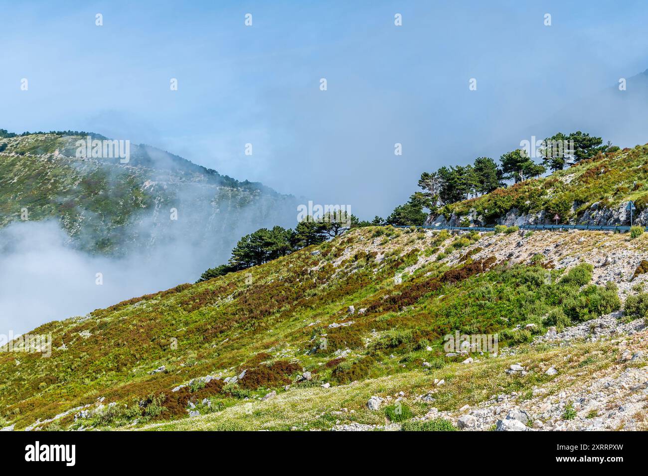 A view of a mist approaching the road in the Llogara National Park ...