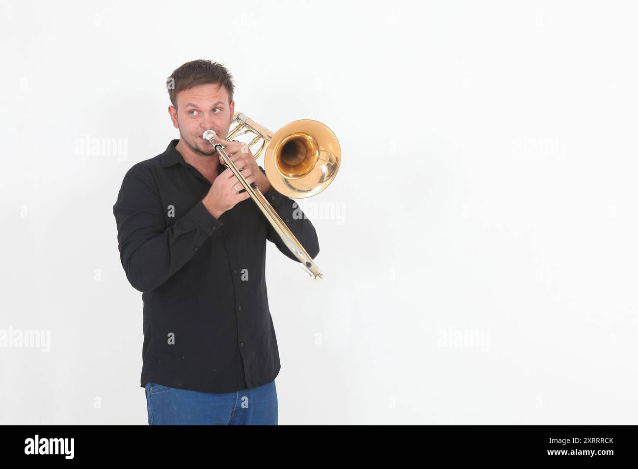 handsome young man with trombone on white background Stock Photo - Alamy