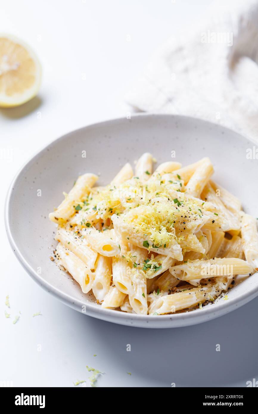 Creamy lemon pasta with chili flakes in white bowl Stock Photo - Alamy