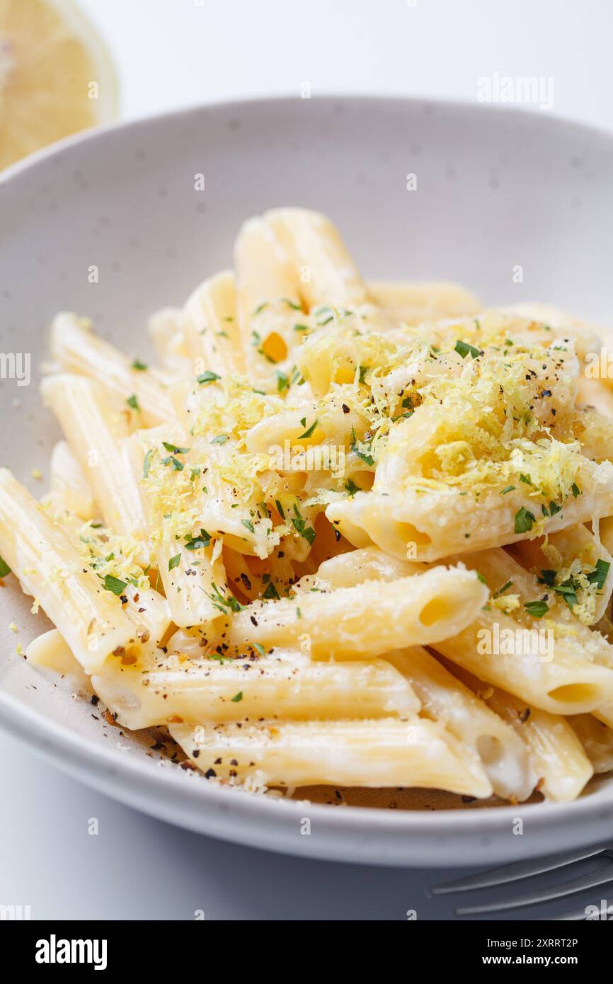 Creamy lemon pasta with chili flakes in white bowl Stock Photo - Alamy
