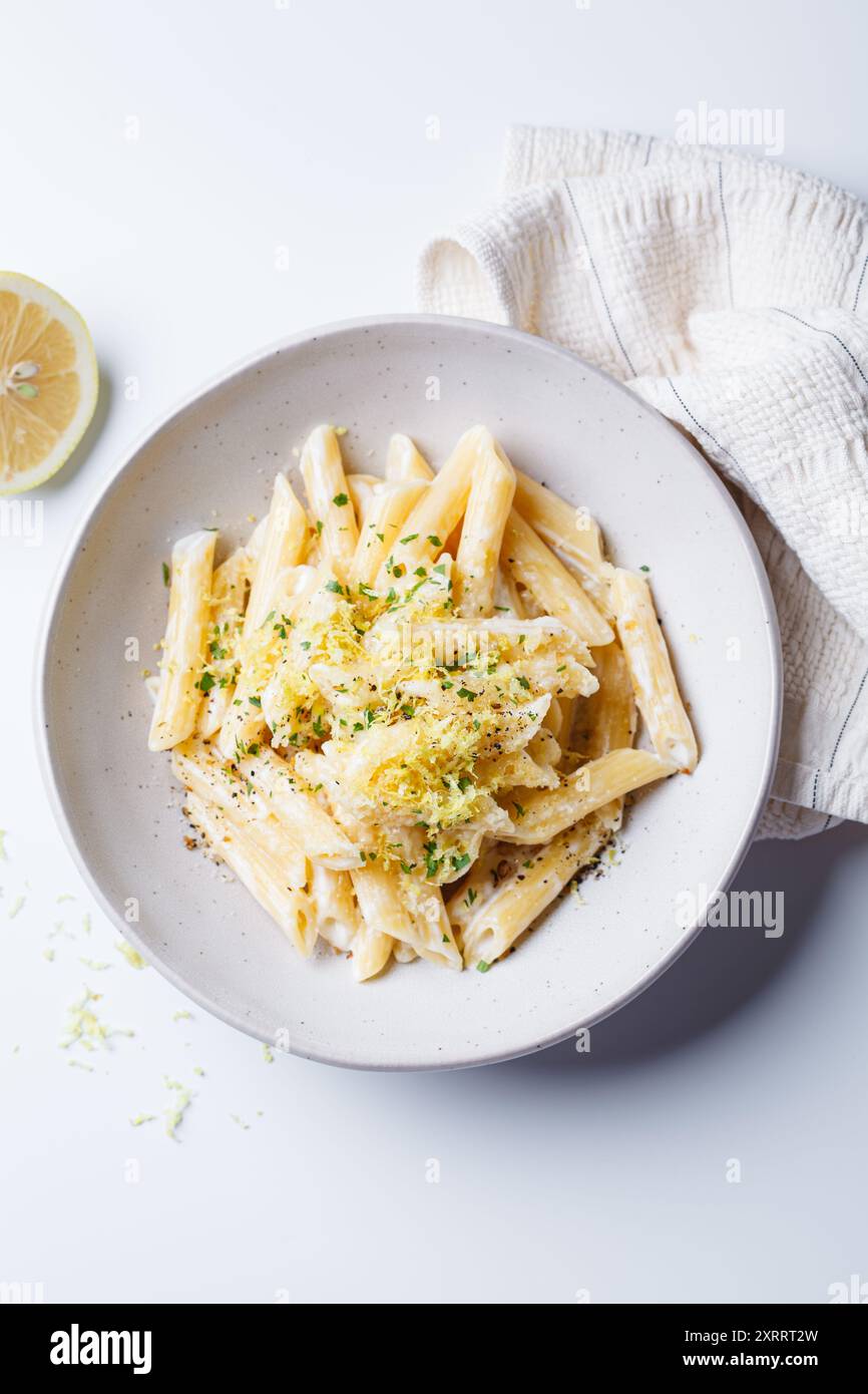 Creamy lemon pasta with chili flakes in white bowl, top view Stock ...