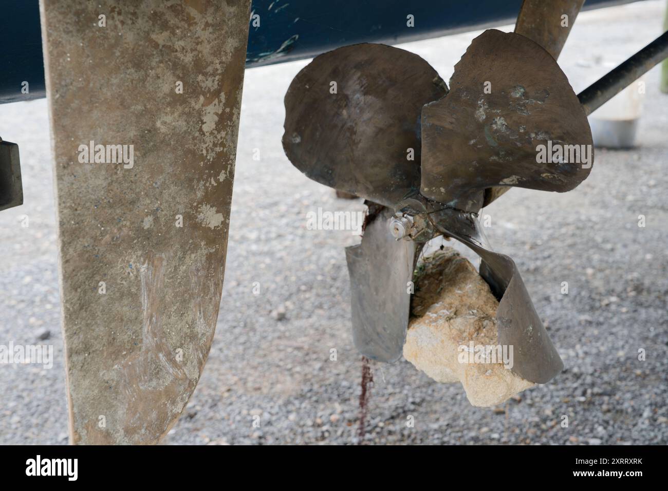Propeller of a motor boat which had run aground, with rock still ...
