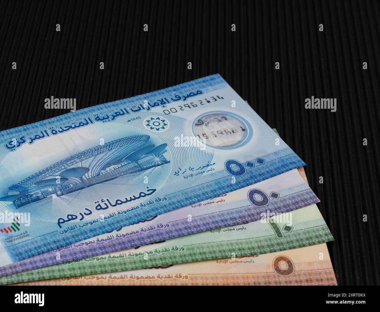 Emirate new plastic banknotes of 5, 10, 50 and 500 dirhams on black ...
