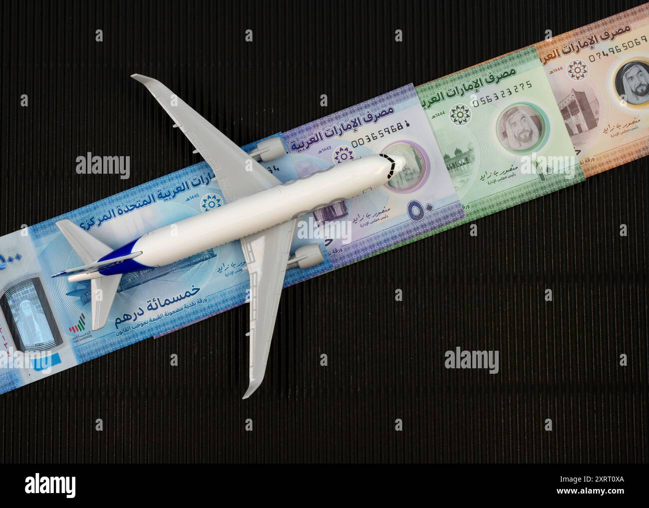 A runway made of UAE currency notes. Toy airplane on the runway of ...