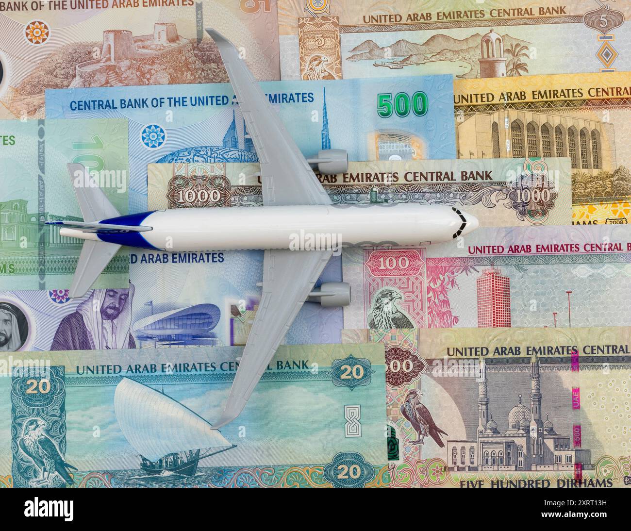 Miniature scale toy passenger aeroplane on emirates currency notes ...