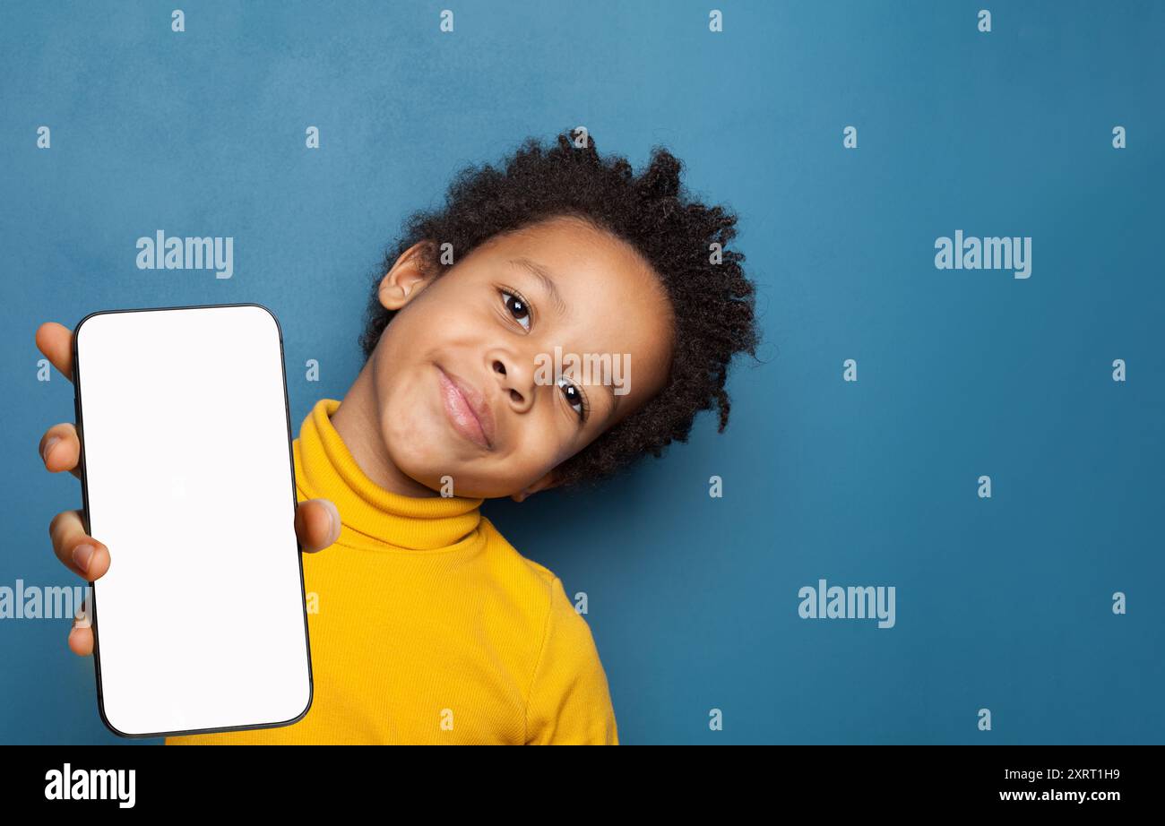 Mischievous child with mobile phone. Kid holding cell phone in his hand ...