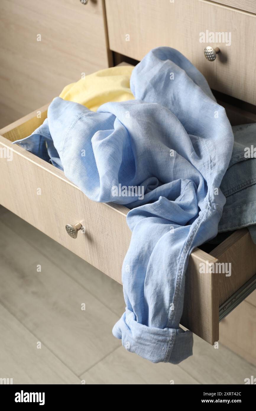 Cluttered chest of drawers, closeup. Clothes in mess Stock Photo - Alamy