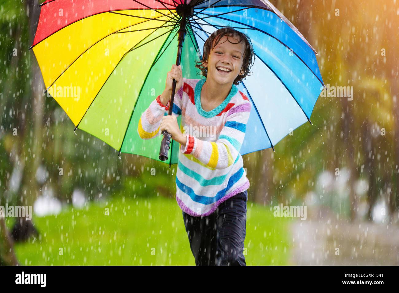 Kid child jumping puddle water splash hi-res stock photography and ...