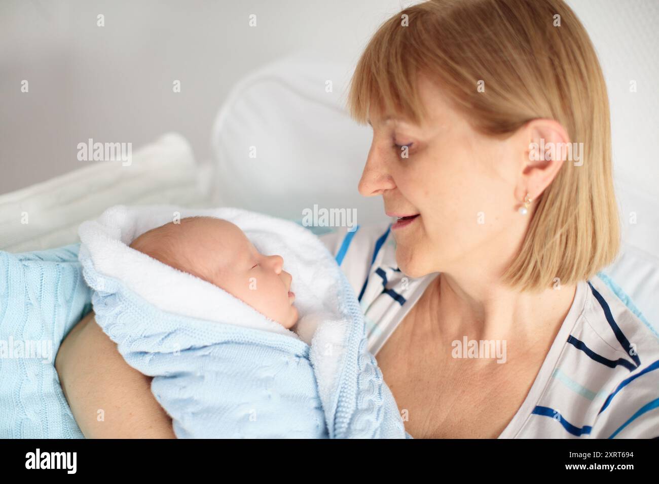 Grandmother holding newborn baby. Grandma meeting new family member ...