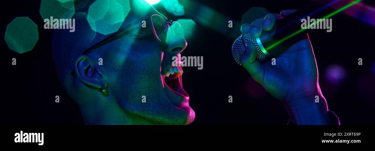 Banner. Singer passionately belts out note, artist's face illuminated ...