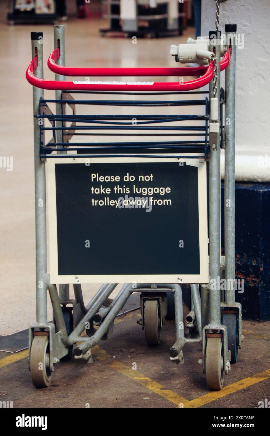 Luggage trolleys stacked at York Station with sign to keep them within ...