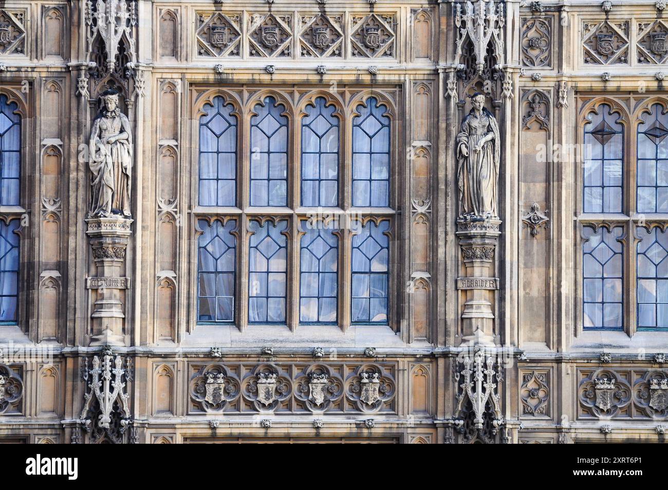 Gothic architecture and statues on historic building facade in London ...