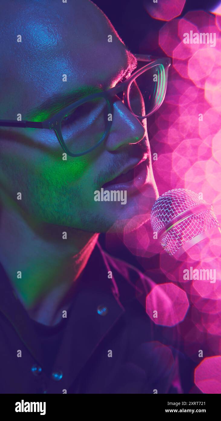 Neon hues reflect off singer's face as he belt out powerful note ...