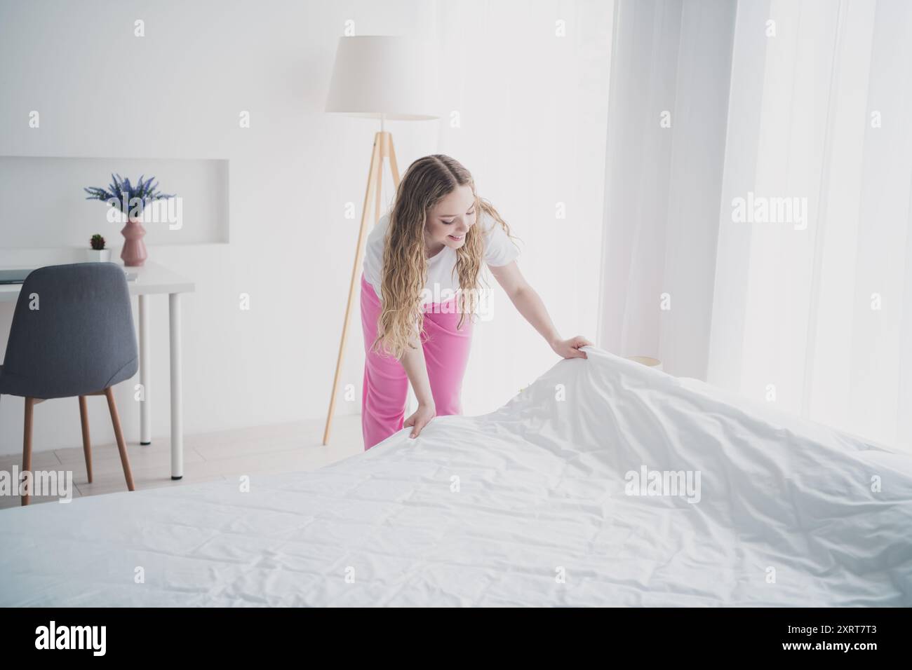 Full body photo of sweet pretty teen girl making bed morning routine ...