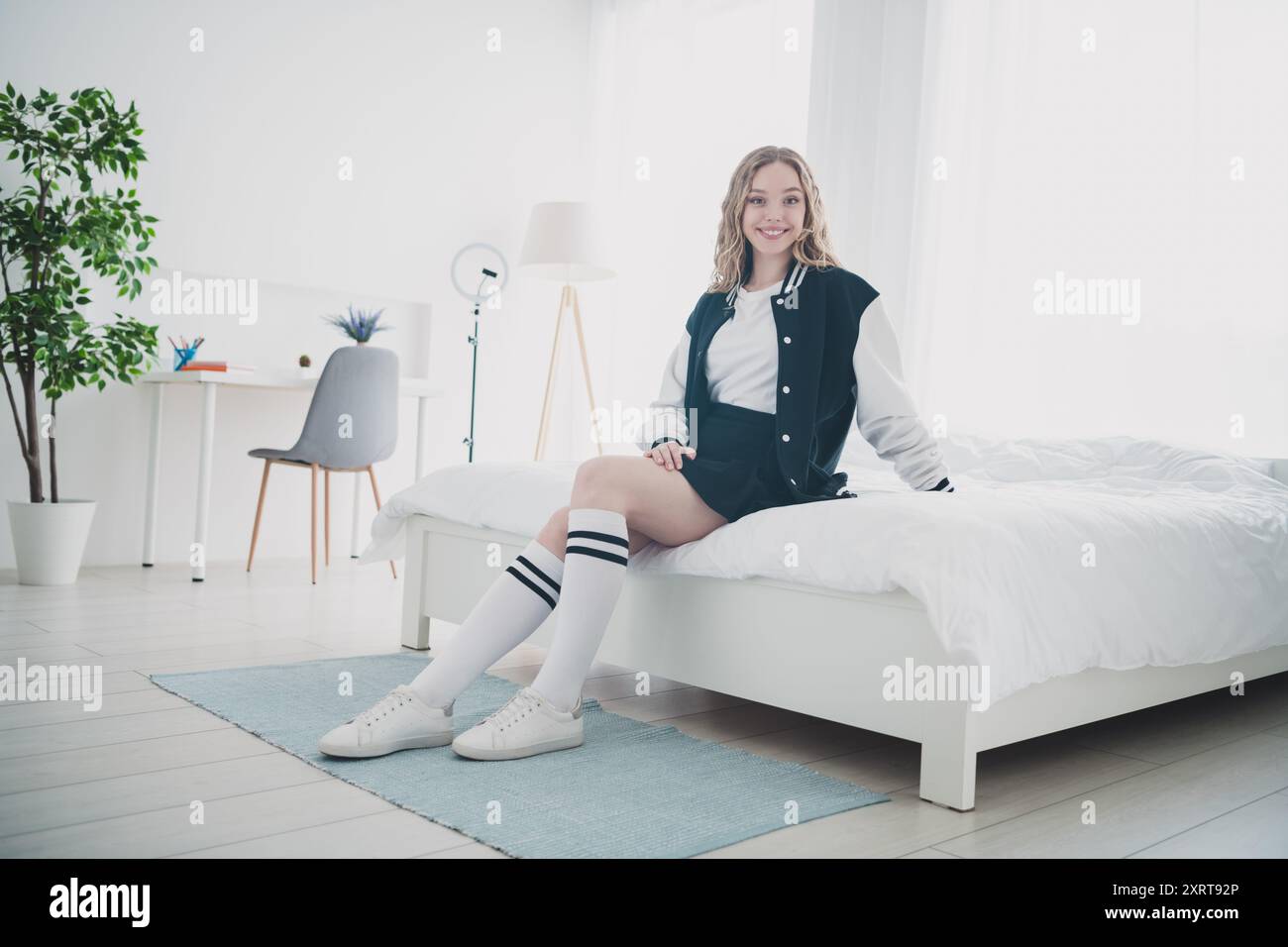 Full body photo of sweet pretty teen girl sit bed relax wear stylish ...