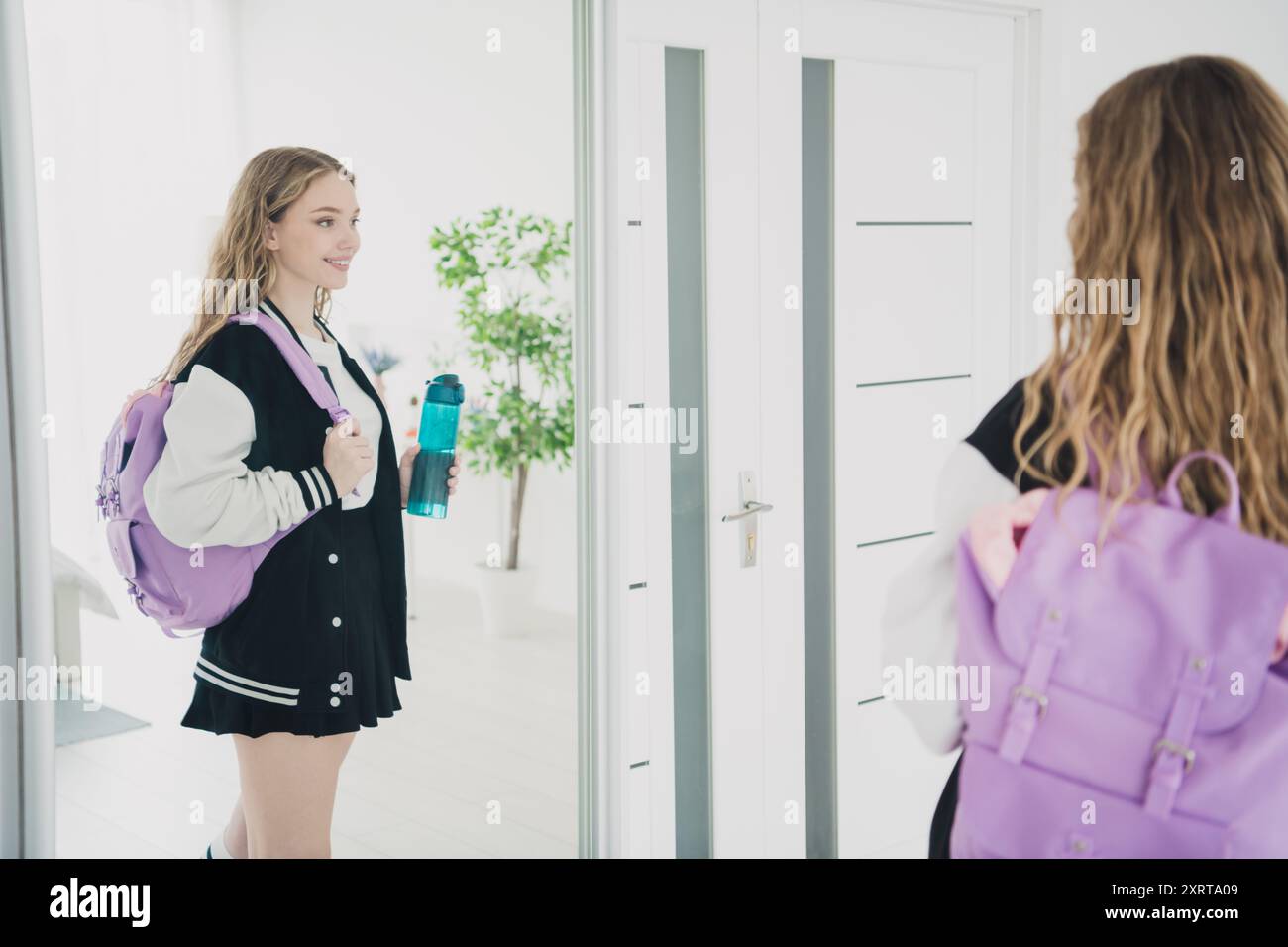 Full body photo of pretty teen girl hold water bottle look mirror wear ...