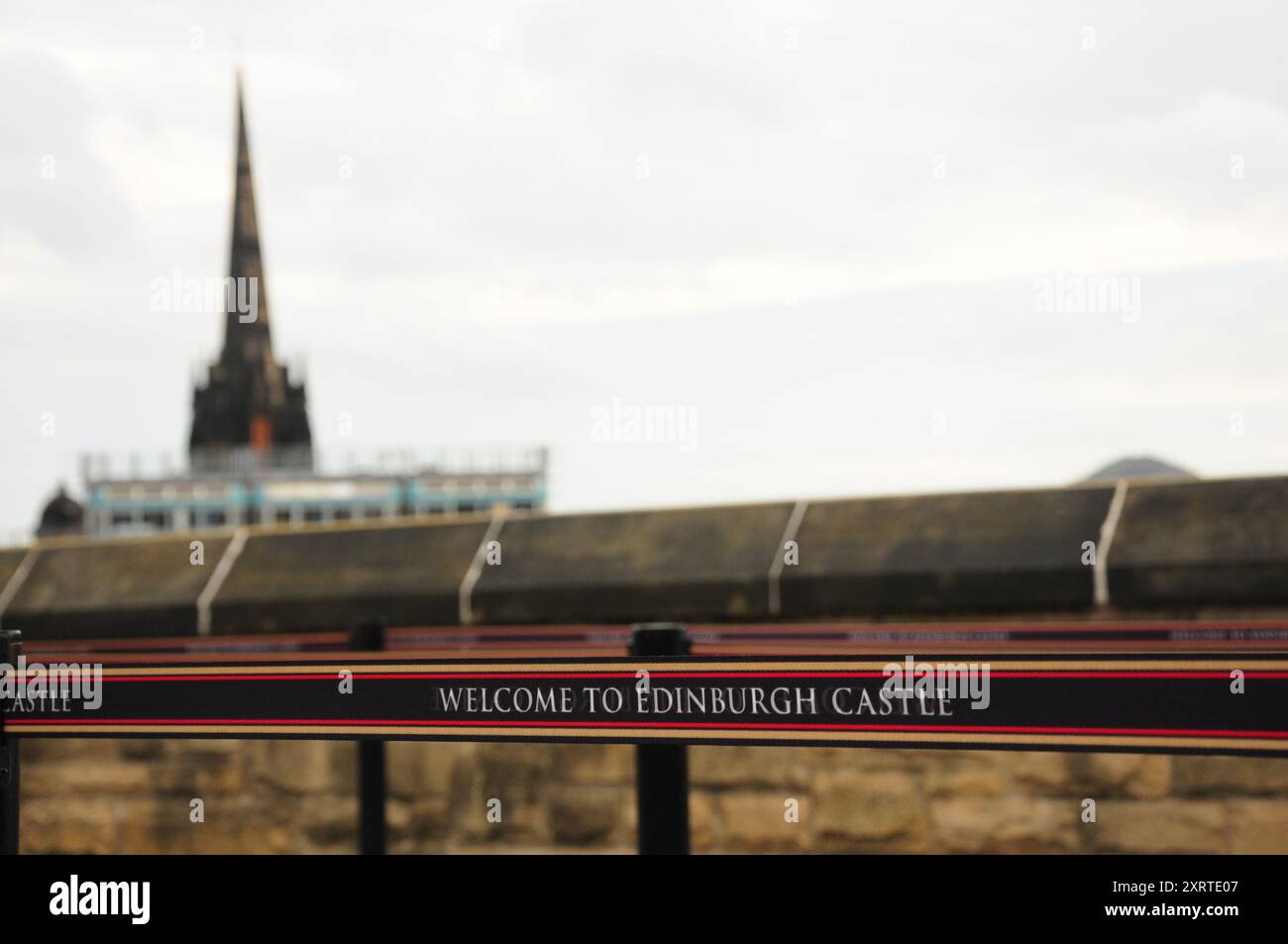 Edinburgh Castle sign with blurred Gothic spire, symbolizing Scottish ...