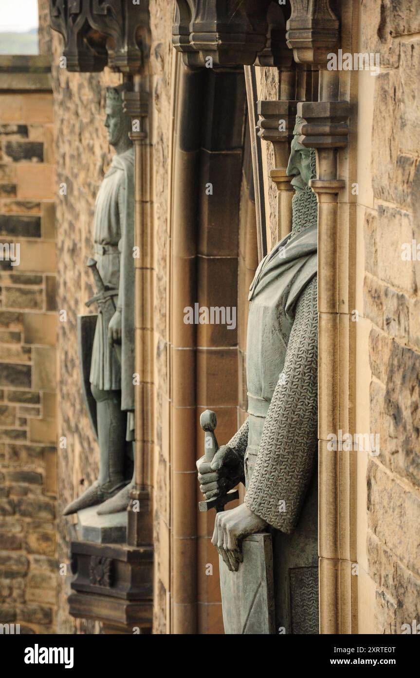 Medieval stone statues against classic brick wall architecture Stock ...
