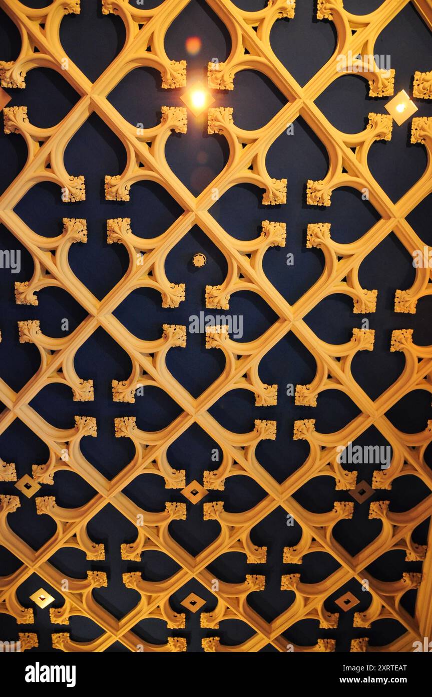 Geometric wooden lattice ceiling design illuminated by warm light Stock ...