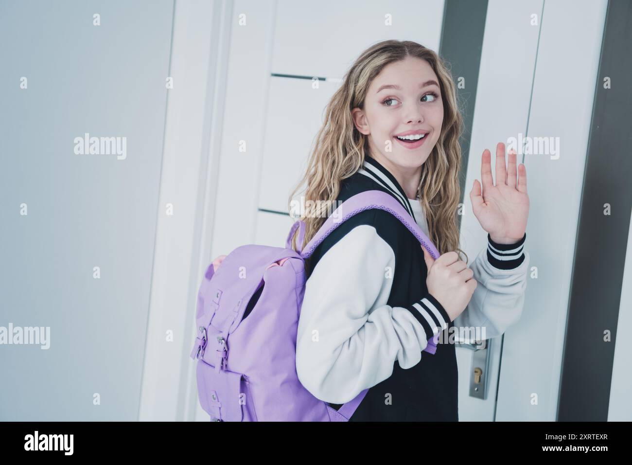 Photo of sweet pretty teen girl exit room wave hand bye wear stylish ...