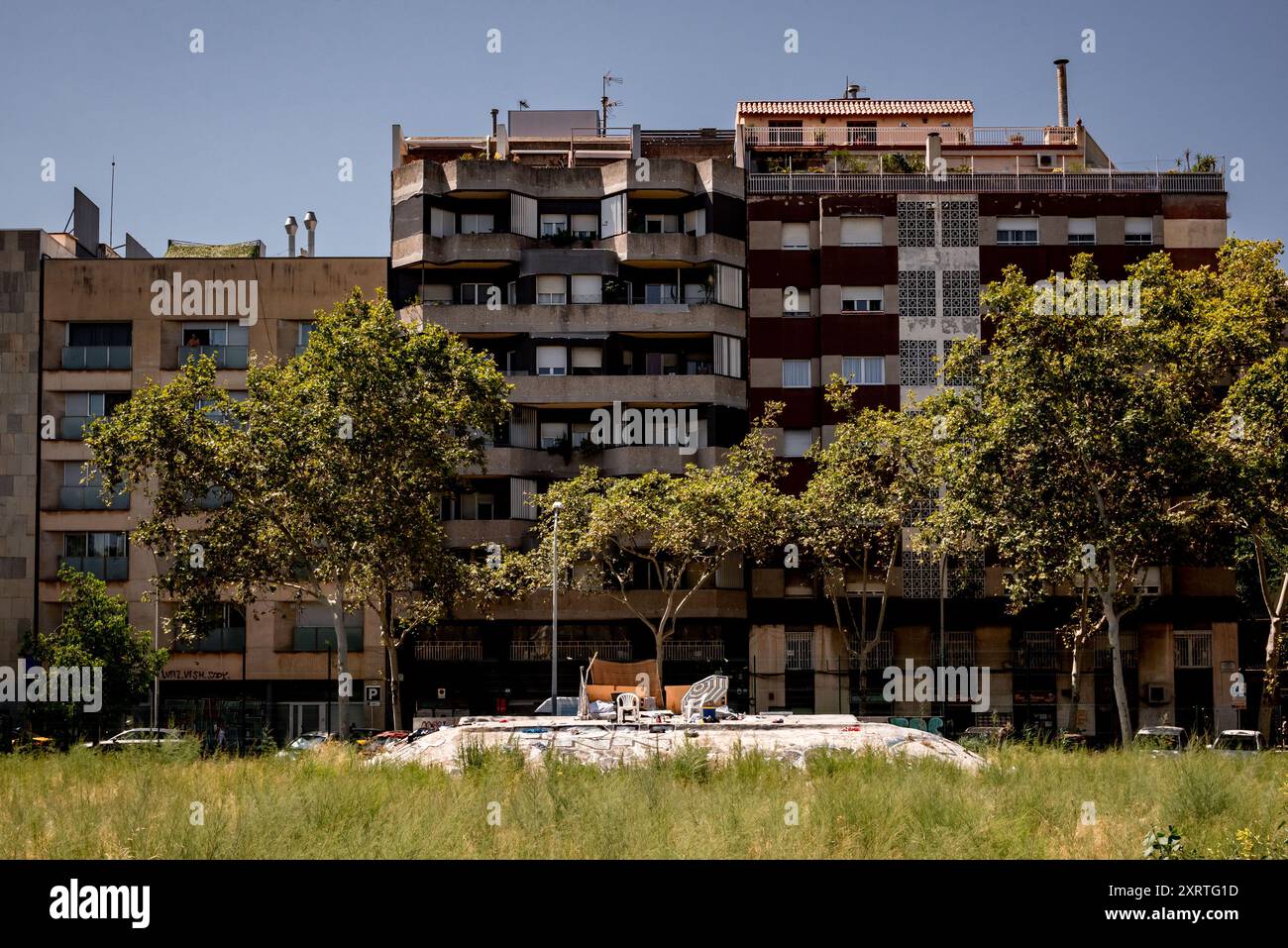 The remains of a homeless camp can be seen in front of a block of ...