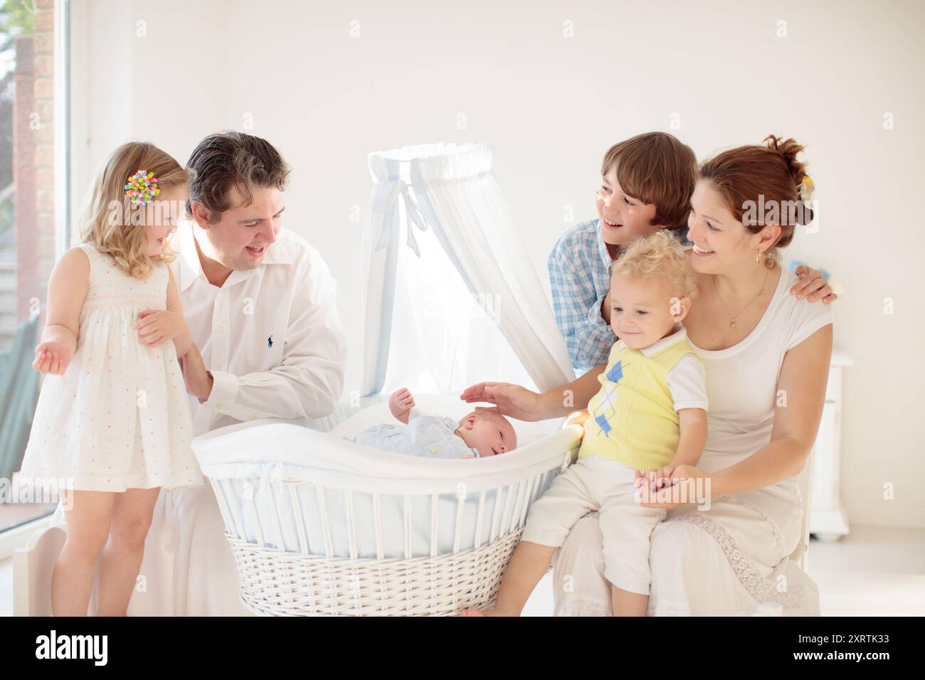 Big family with four kids in white bedroom. Parents and kids standing ...