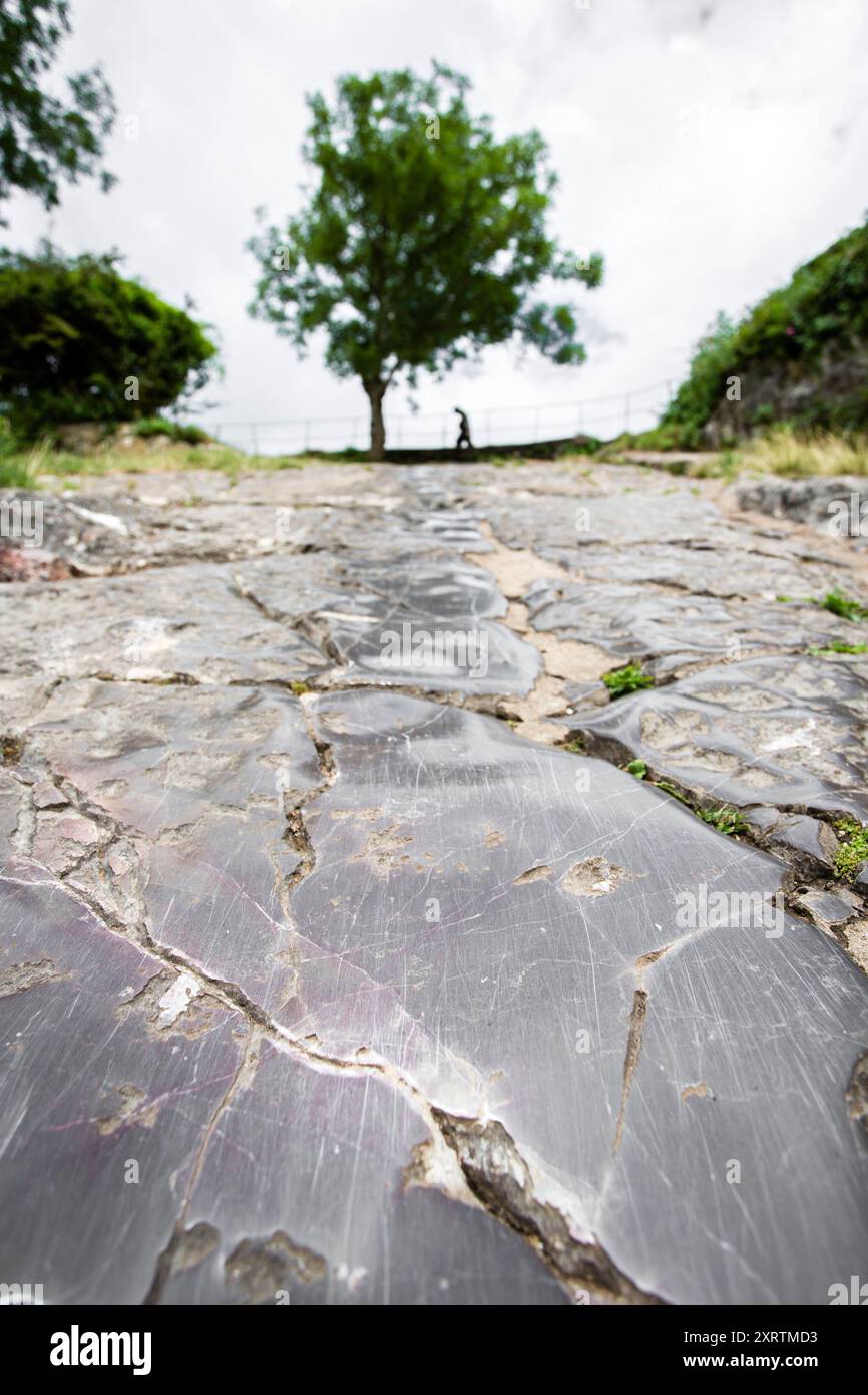 A large stone covered hillside, often used as a natural slide by ...