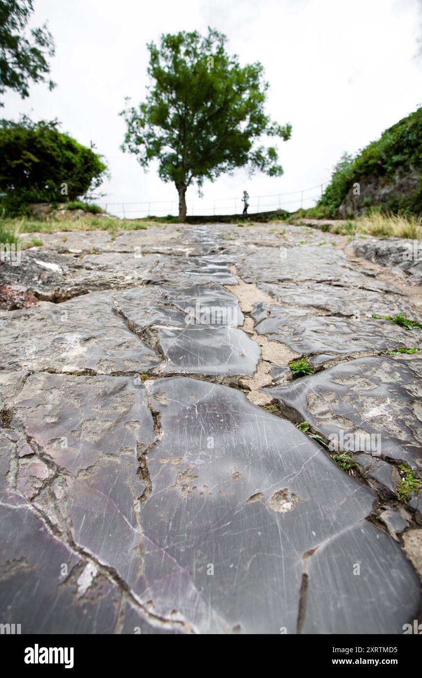 A large stone covered hillside, often used as a natural slide by ...