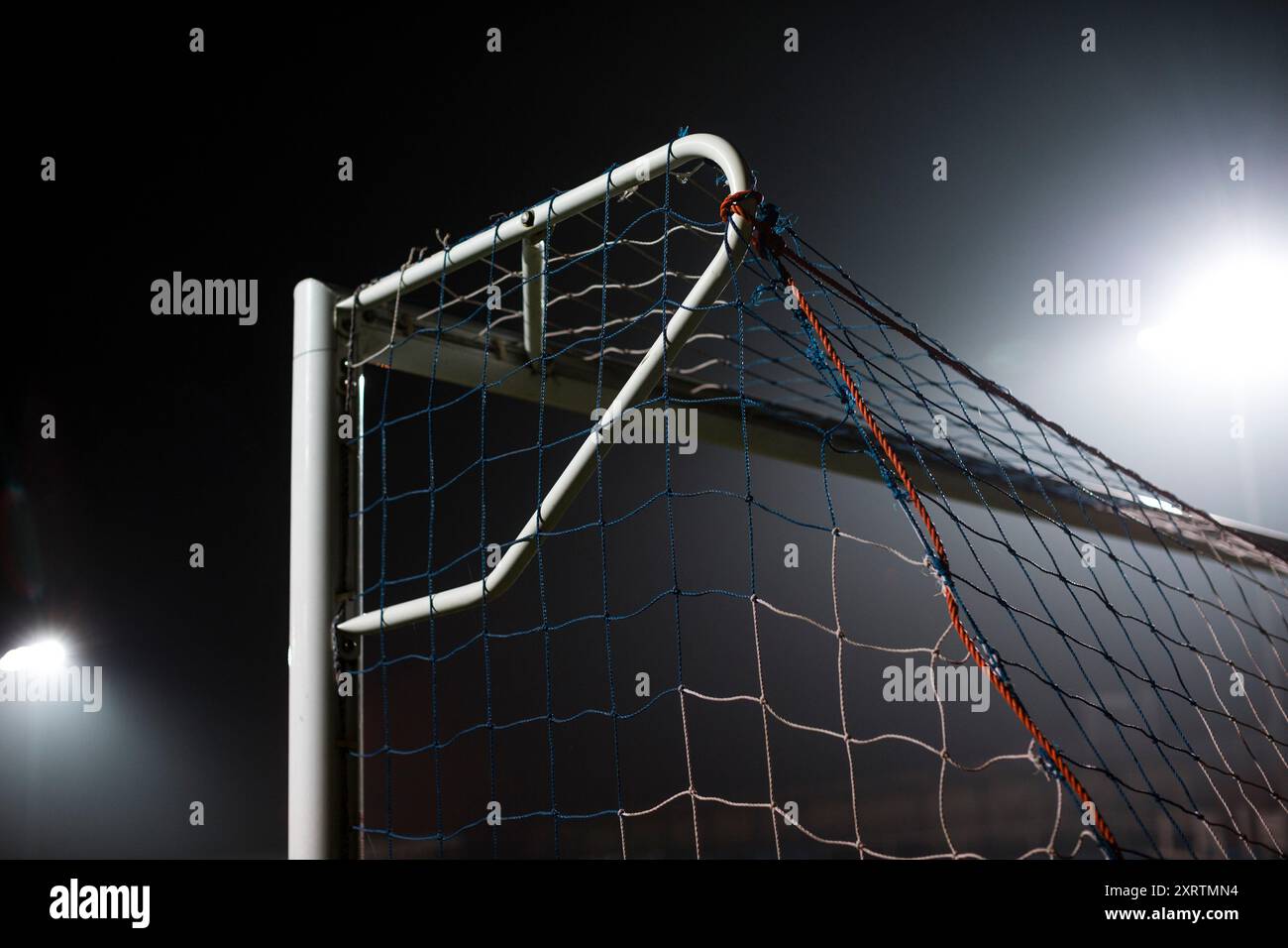 Local football match with goal and net at night under spotlights Stock ...