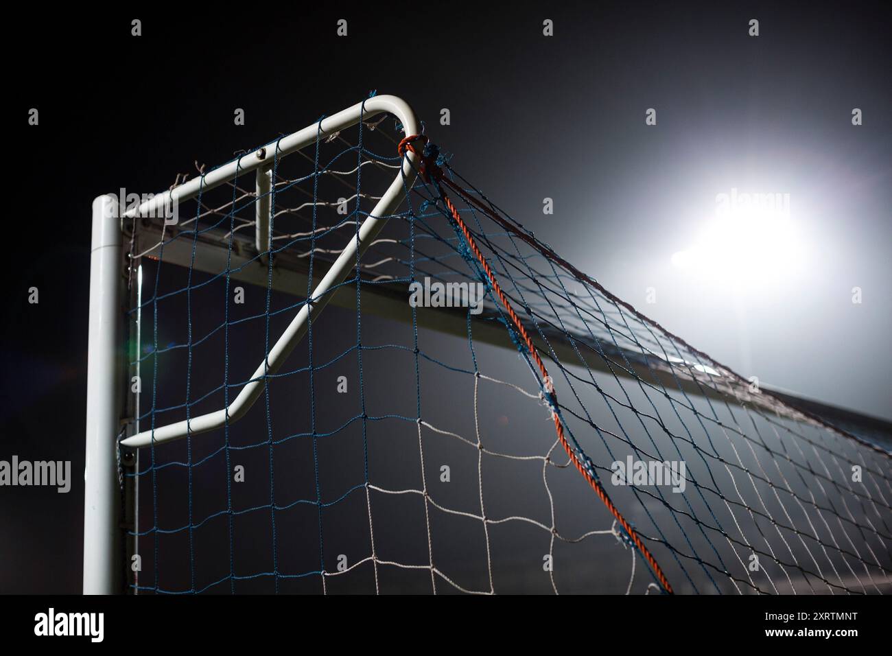 Local football match with goal and net at night under spotlights Stock ...