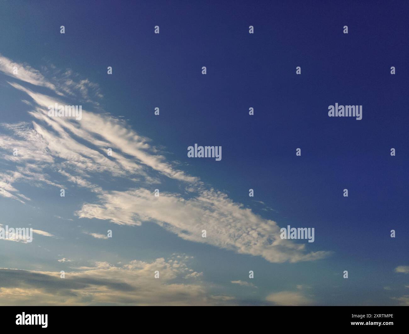 A blue sky with a few clouds. The sky is clear and bright, with no ...