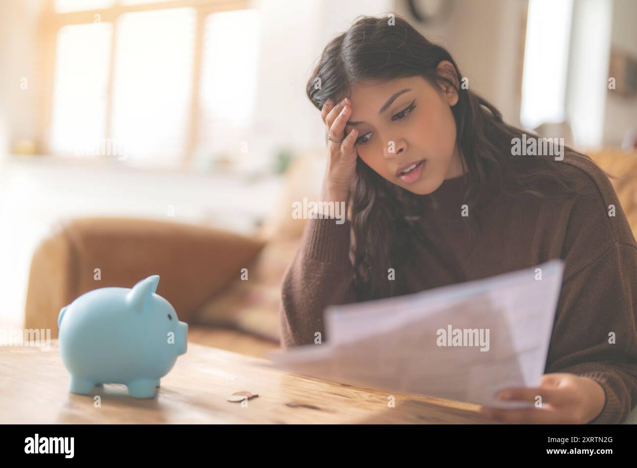 Worried young indian woman reading letter savings employment tax paying ...
