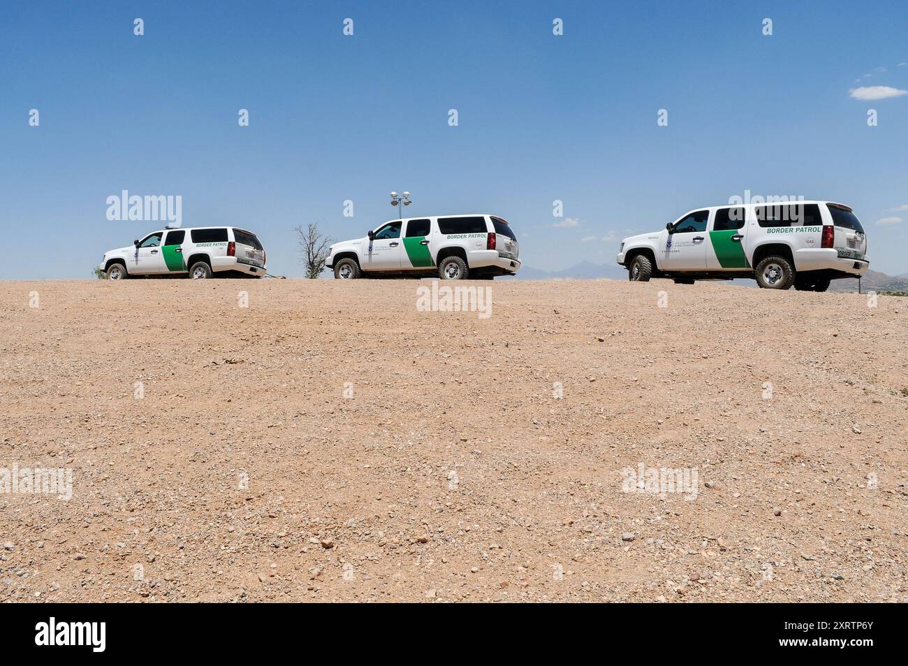 Three Border Patrol vehicles parked near the Mexico–United States ...