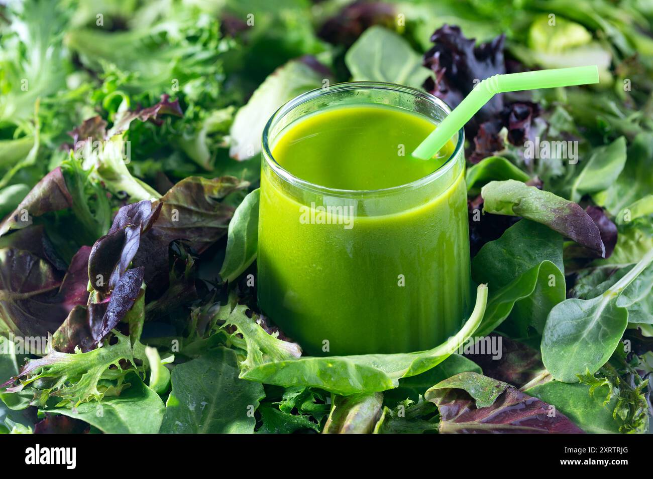 Glass of organic fresh green juice made from leafy green vegetables ...