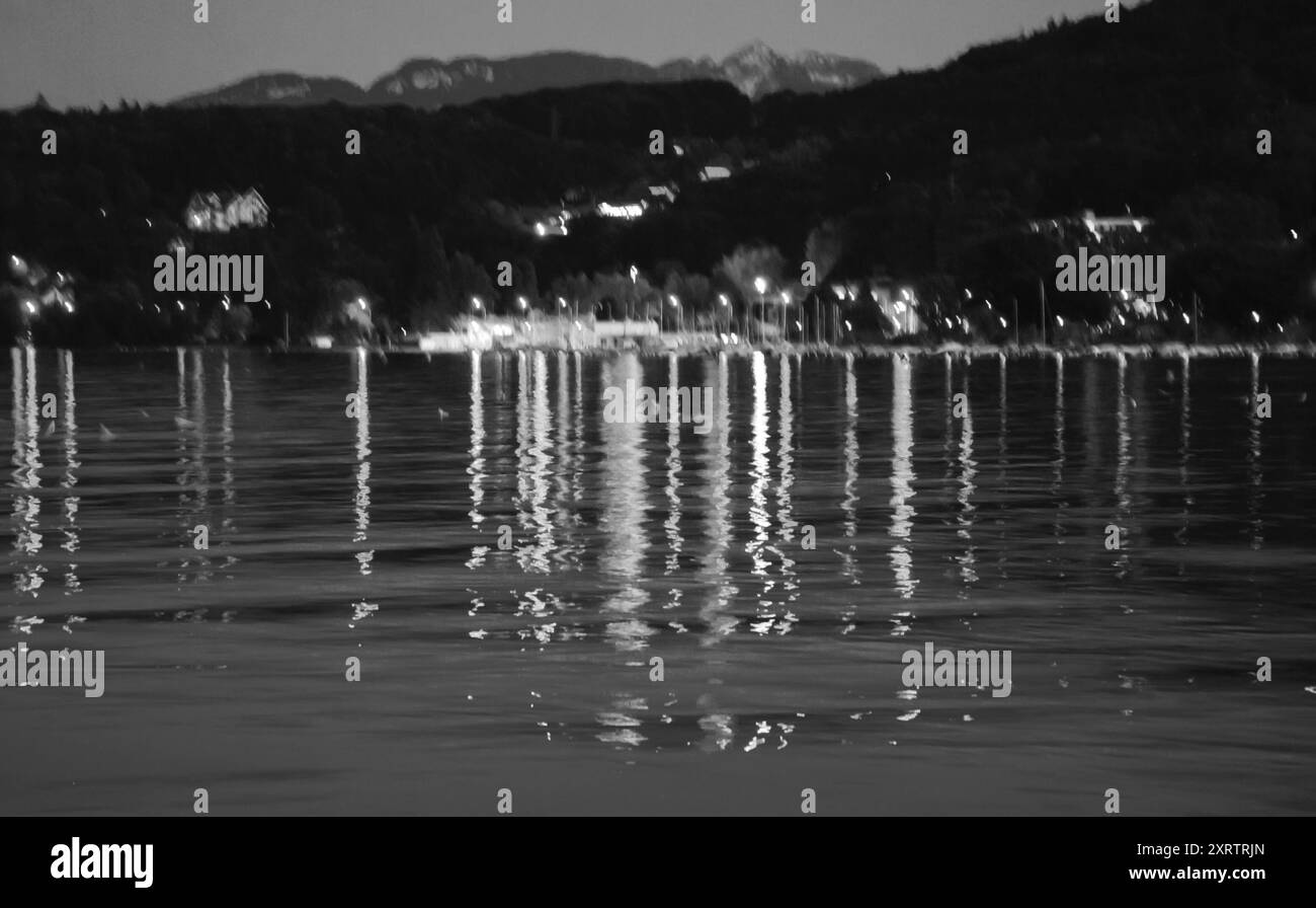 Blurry photo of Annecy Lake in the evening with glowing lights ...