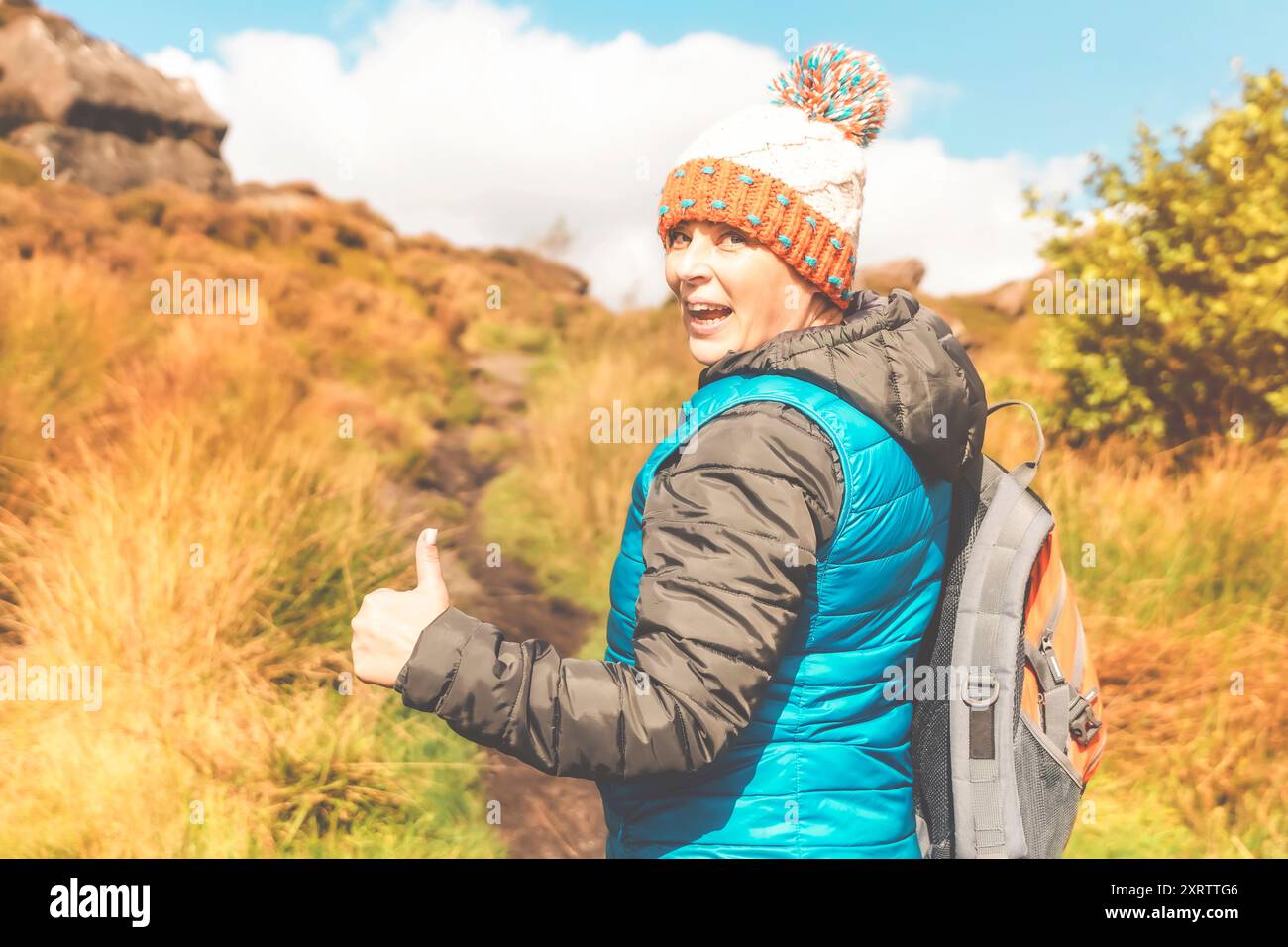 Happy woman tourist giving thumb up, hiking, and exploring, enjoying ...