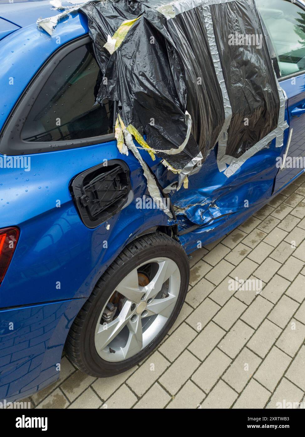 Damaged Blue Car with Temporary Repair Stock Photo - Alamy