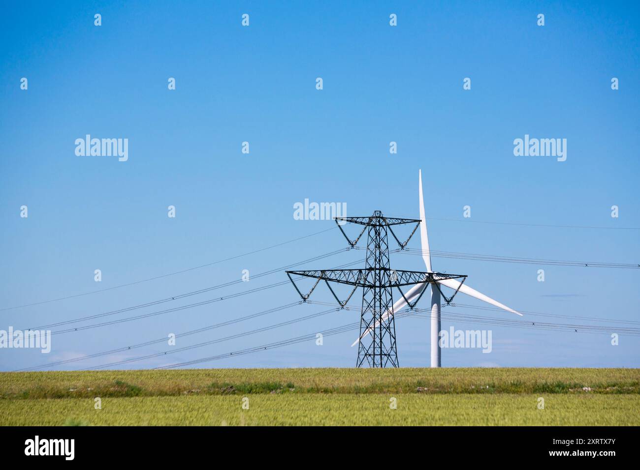 A wind turbine spinnign in the wind, generating power and partially ...