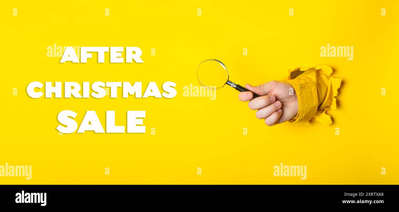 A person holding a magnifying glass with the words After Christmas Sale ...