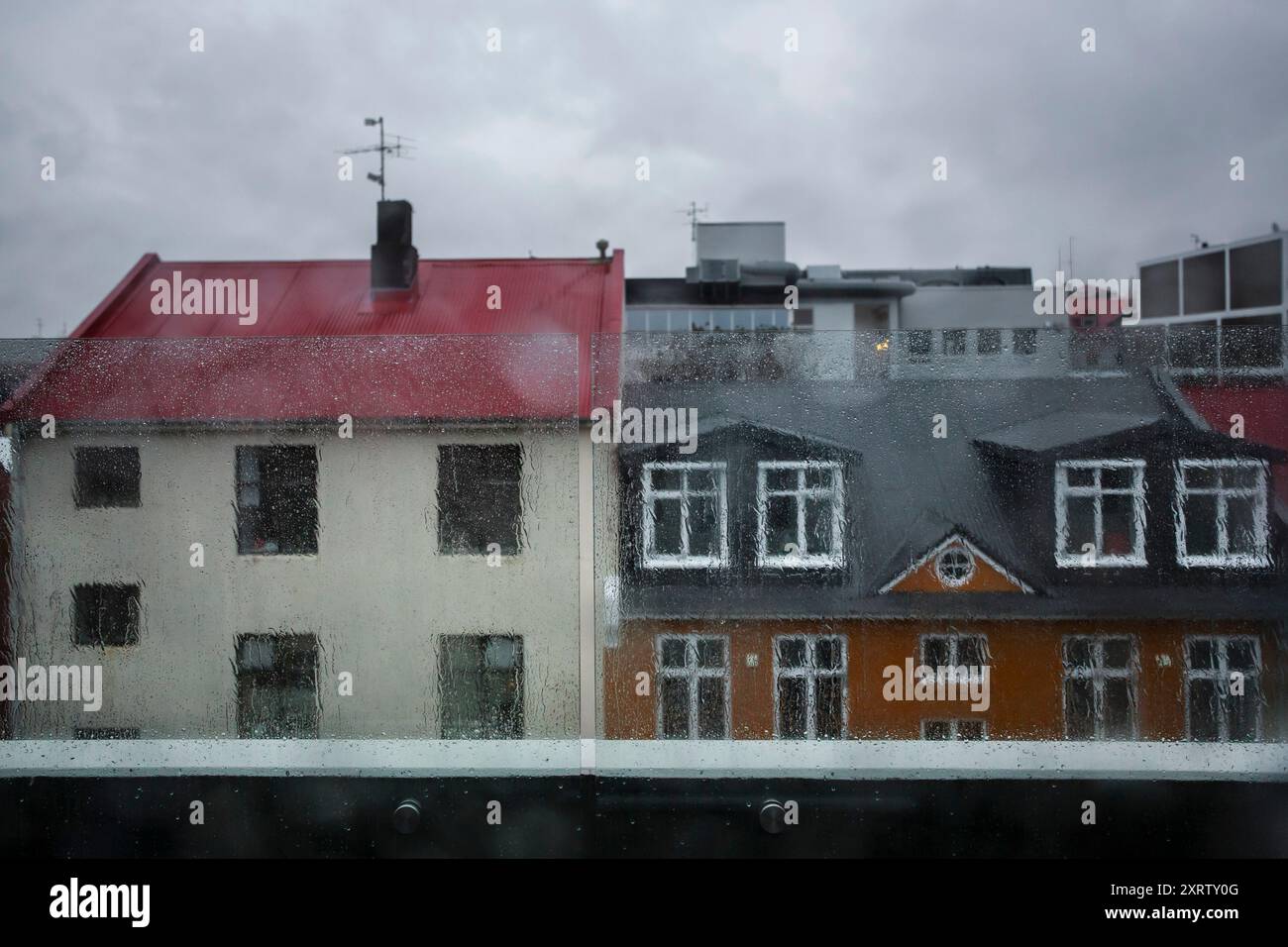 Rooftop view of a street of houses on a grey wet day in the centre of ...