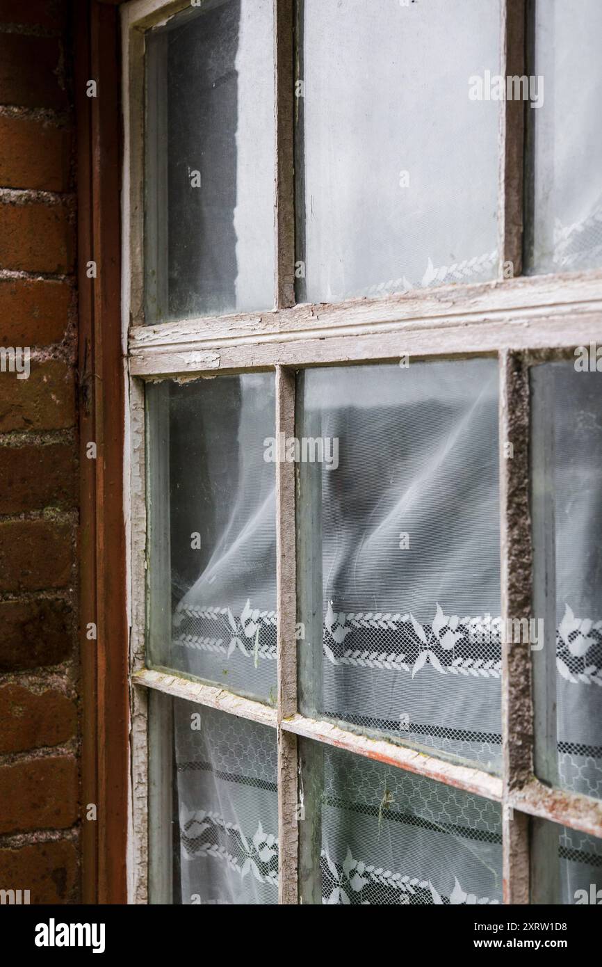 A run down deserted house in the welsh countryside with old lace ...