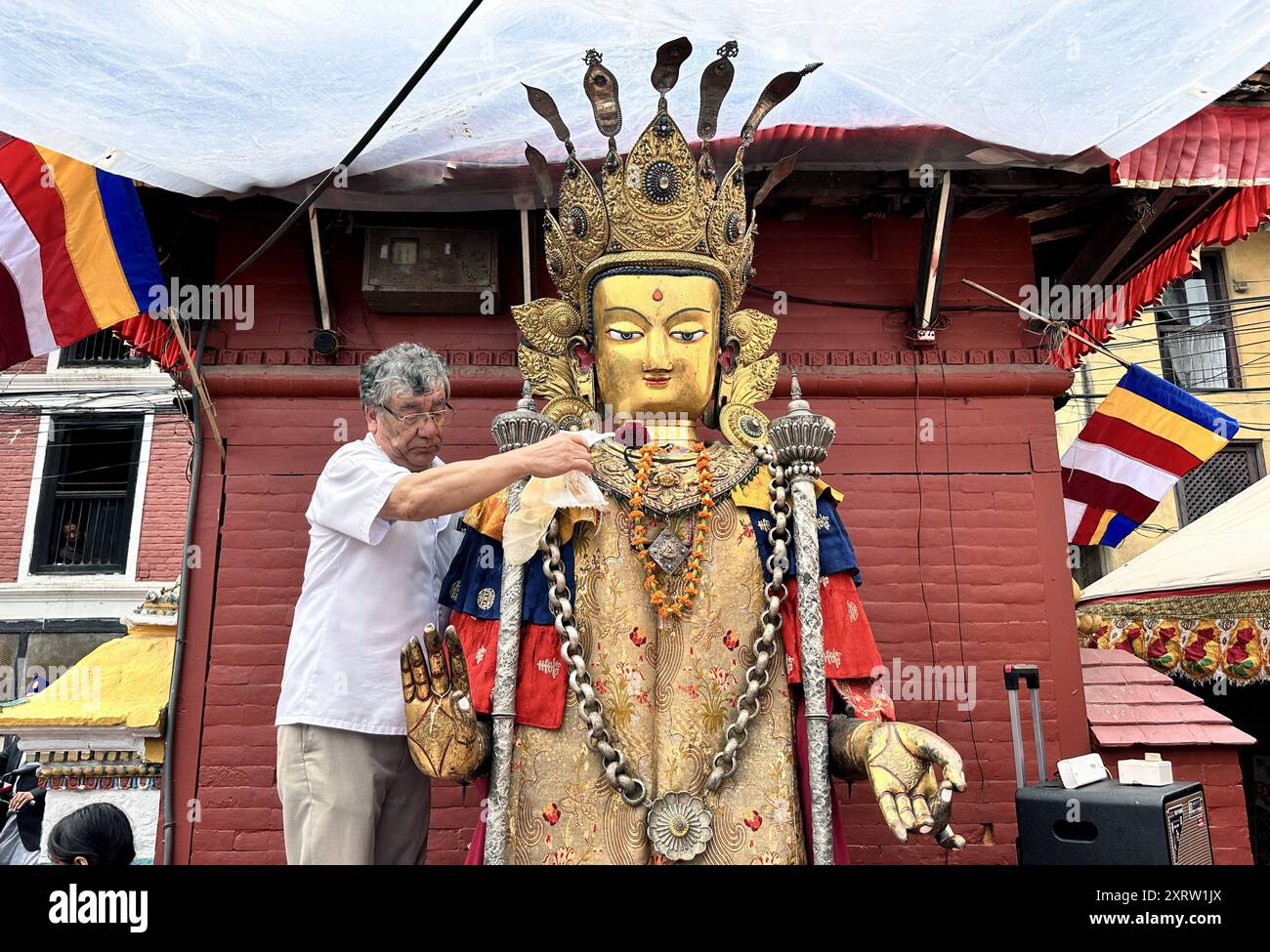 August 12, 2024: A devotee offers prayers to Dipankar Buddha during the Pancha Dan festival in ...