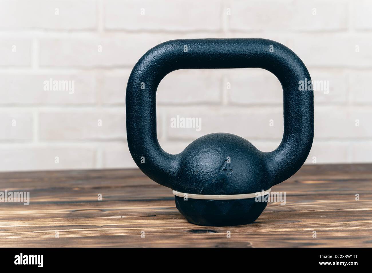 A modern fitness kettlebell On a wooden table. the concept of a healthy ...