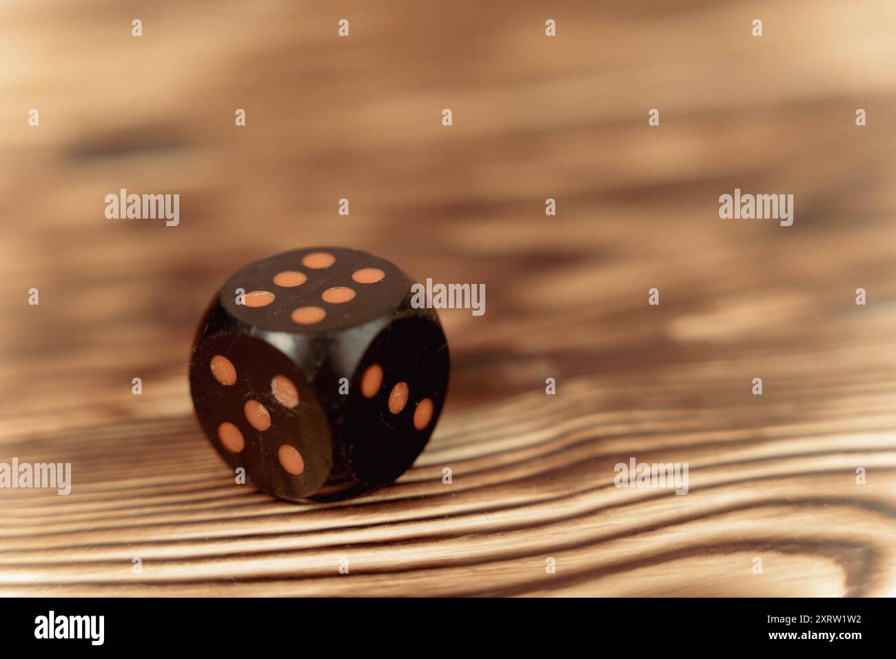 A detailed view of a single dice with clear markings, sitting on a ...