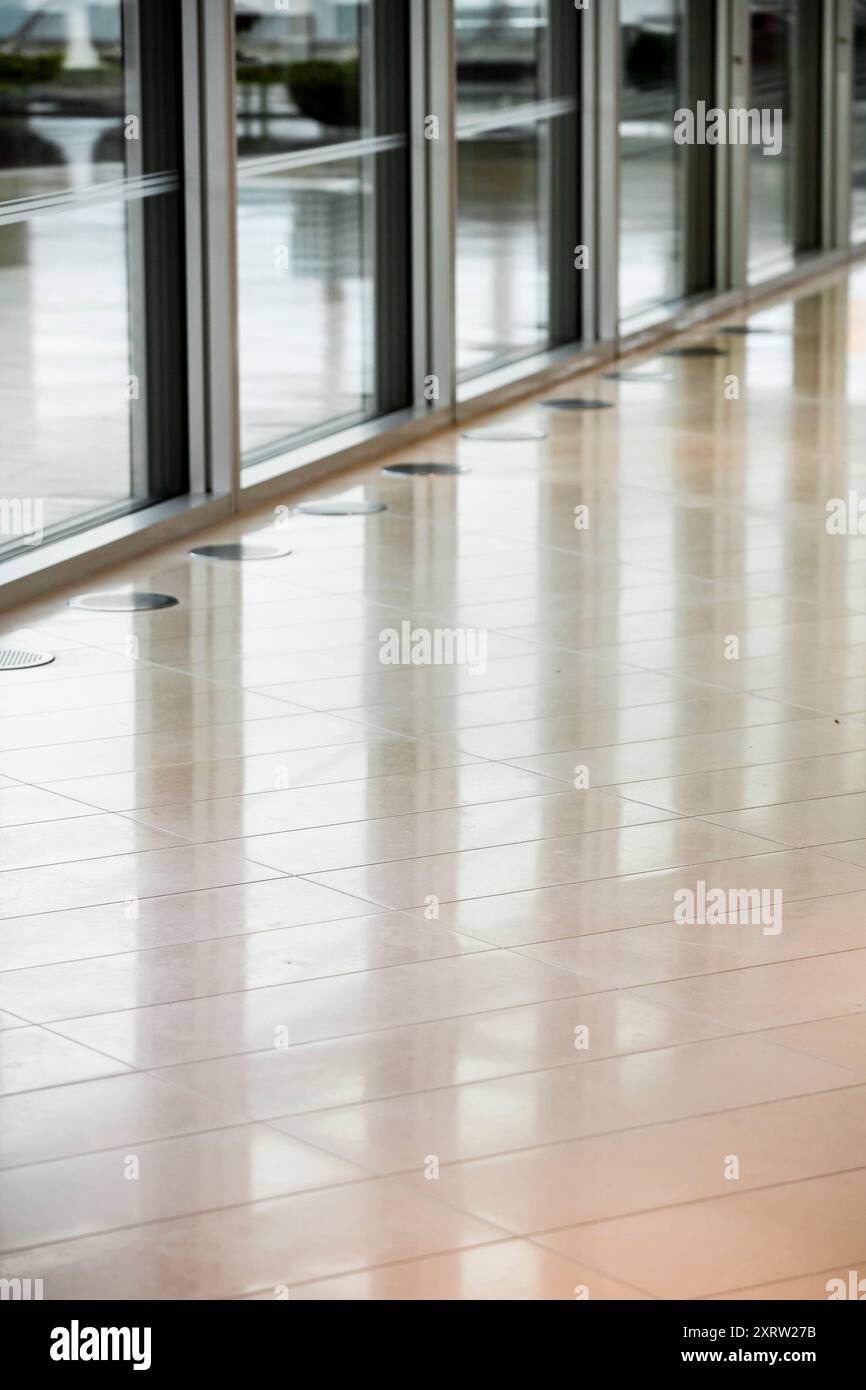 Internal view of an office complex with tiled floor, pillar walkways ...