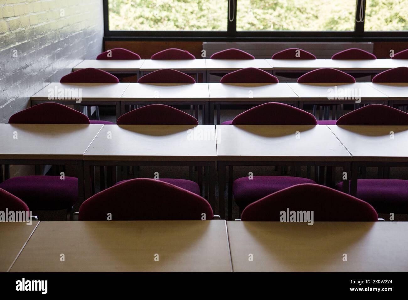 Inside a classroom or lecture room with empty rows of chairs set ...